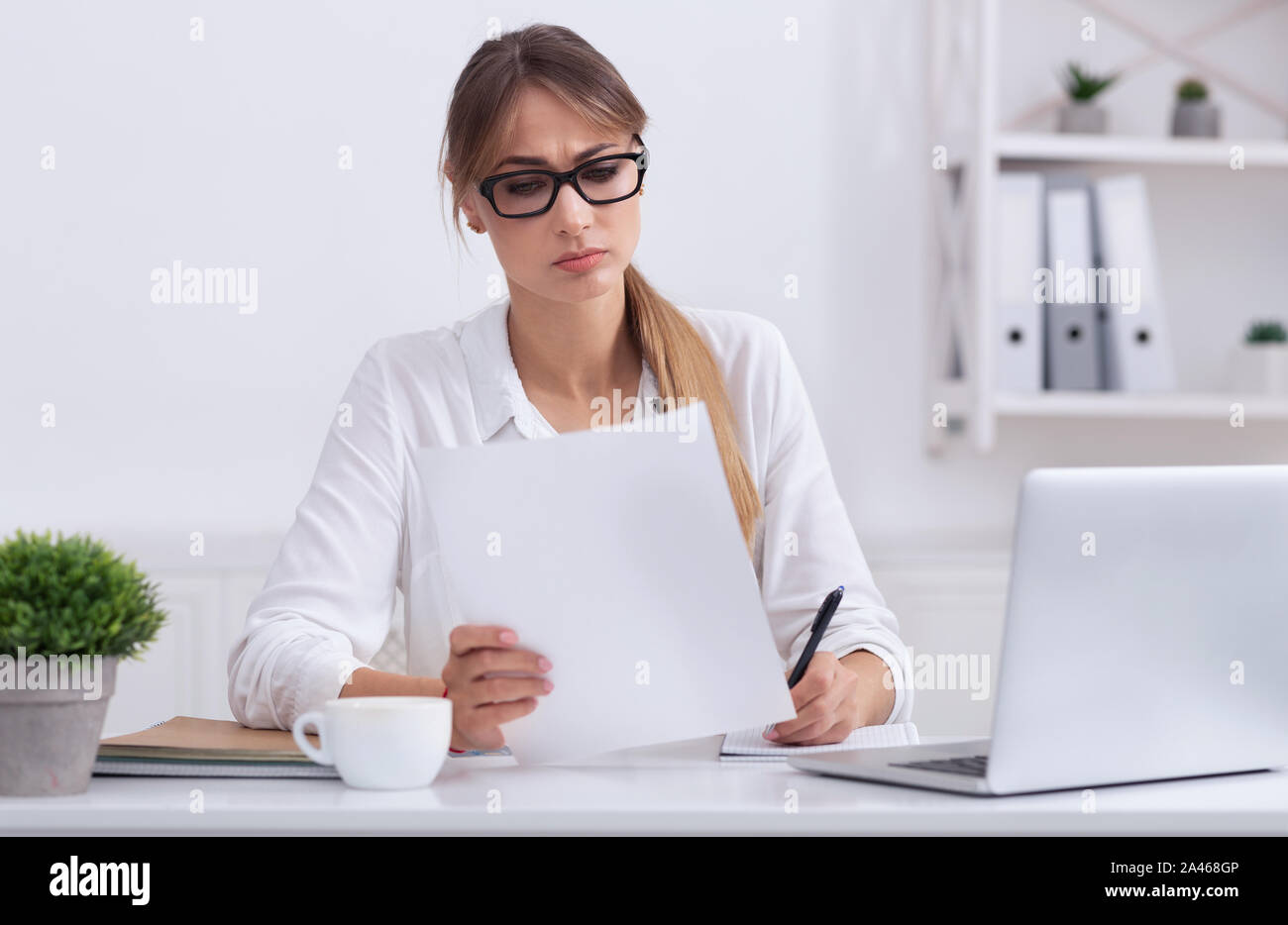 Female Entrepreneur Writing Business Report Working In Office Stock ...