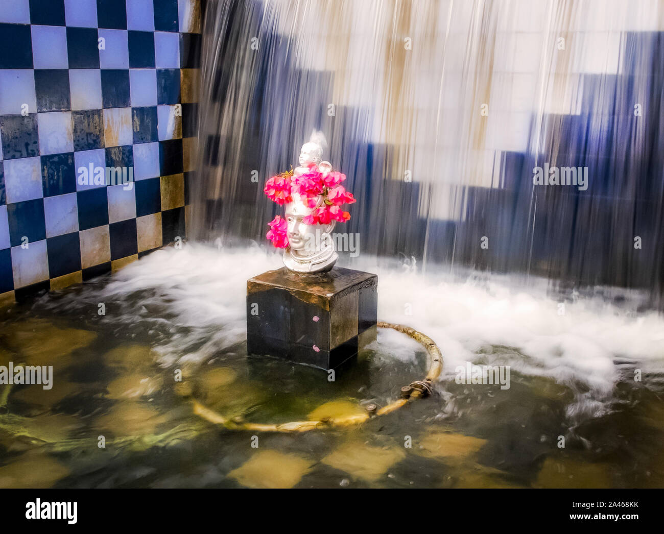 Water cascade and tiled walls surround this beautiful water feature in ...