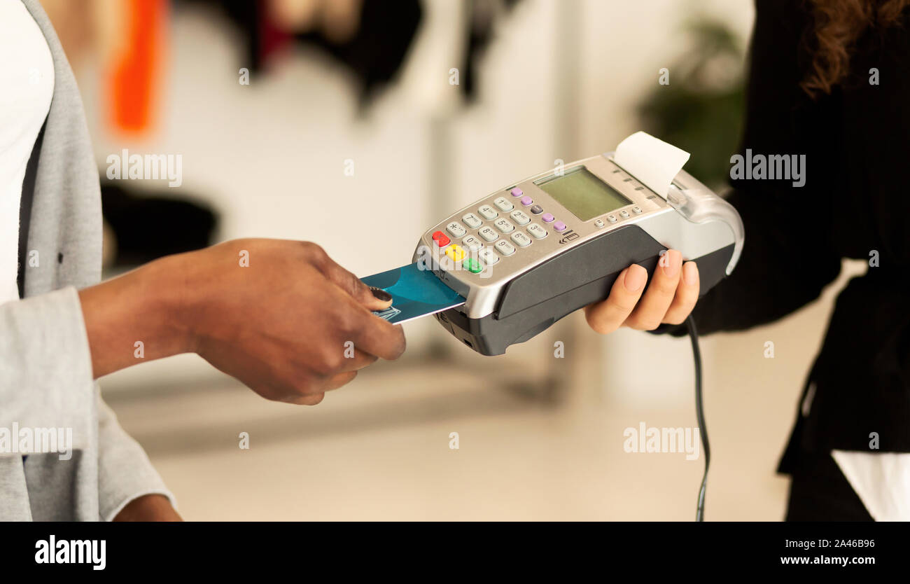 Customer Paying With Credit Card In Fashion Showroom, Closeup, Cropped ...