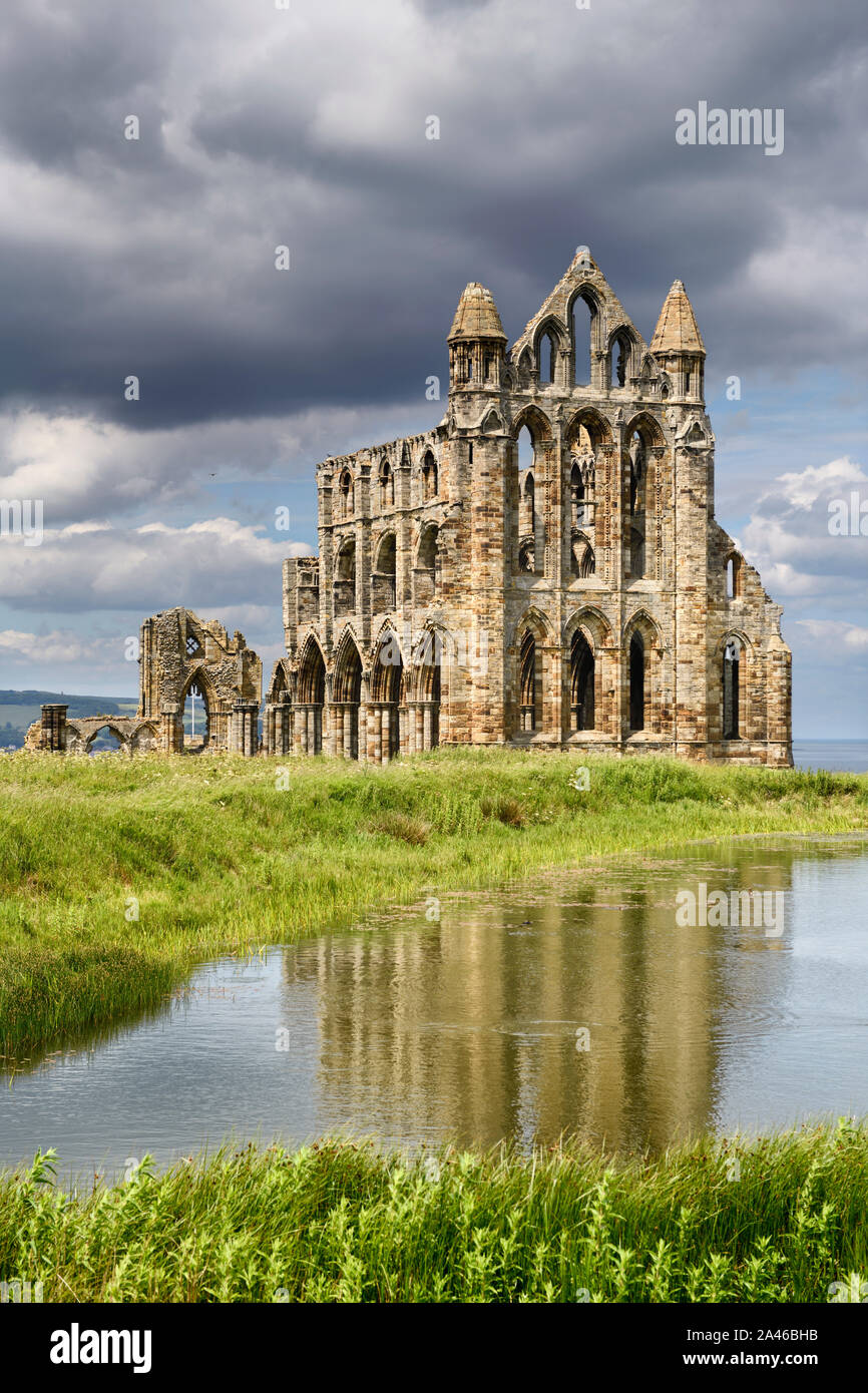 Gothic ruins of 13th Century Whitby Abbey on the North Sea reflected in ...