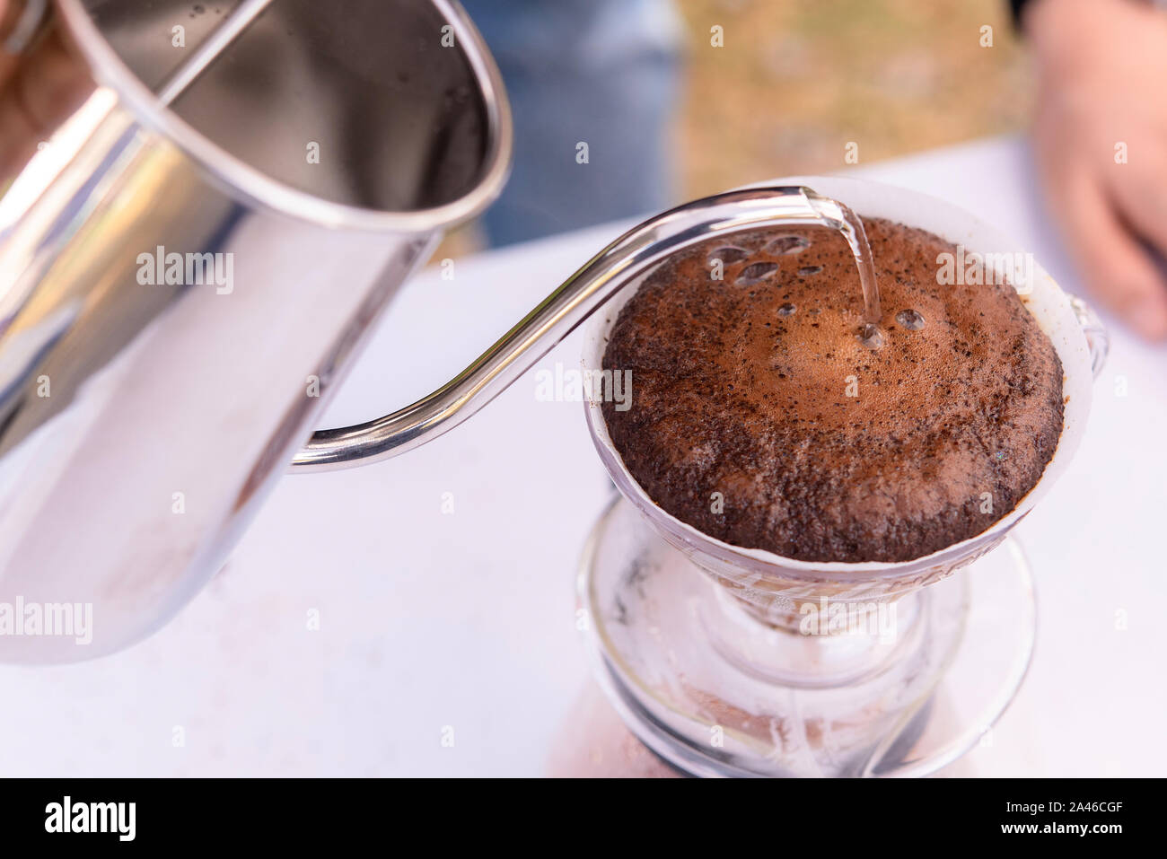 Pouring hot water on ground coffee, hand drip coffee Stock Photo - Alamy