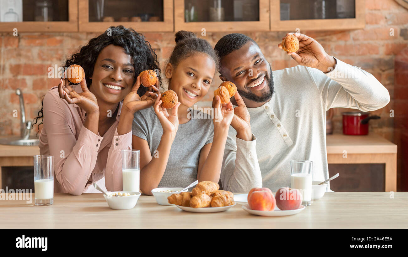 Happy black family playing with cupcakes and laughing Stock Photo - Alamy