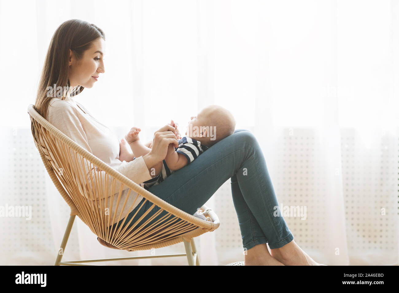 Woman sitting in chair baby in lap hi-res stock photography and images ...