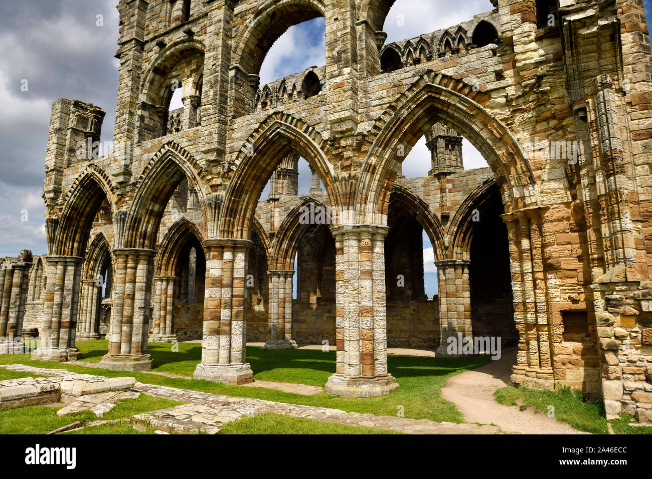 Eroded stone arches and pillars of the Gothic ruins of Whitby Abbey ...