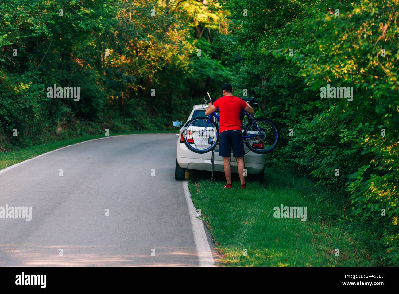 Tired (exhausted) biker puts his bike on a car to get a ride Stock ...
