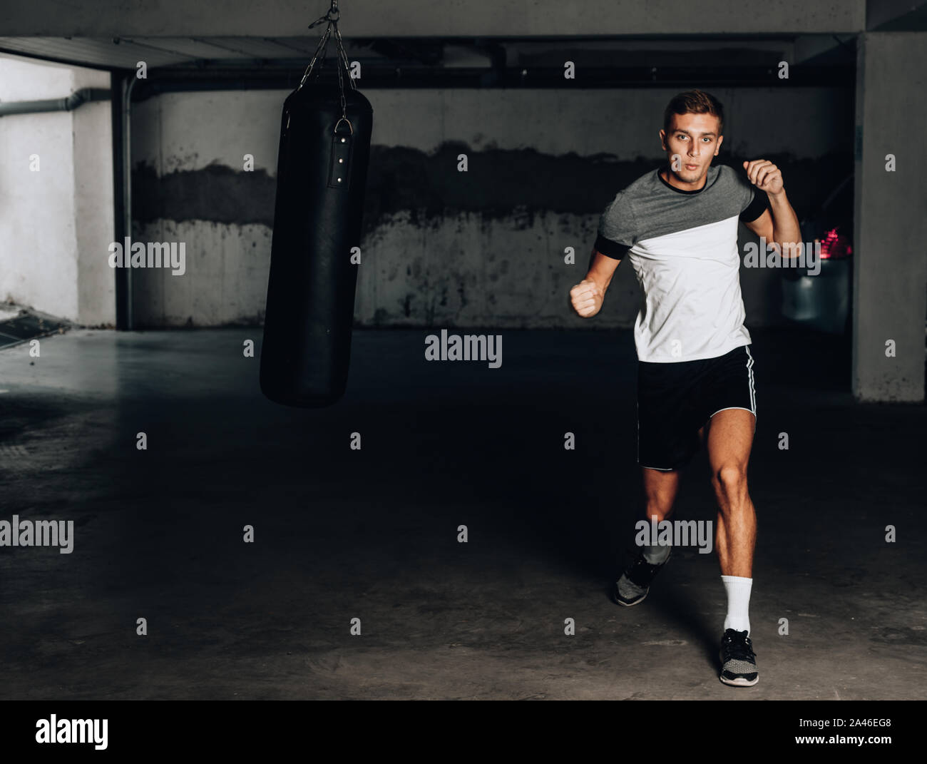 Man throwing a fierce and powerful punch. Photo of muscular man ...