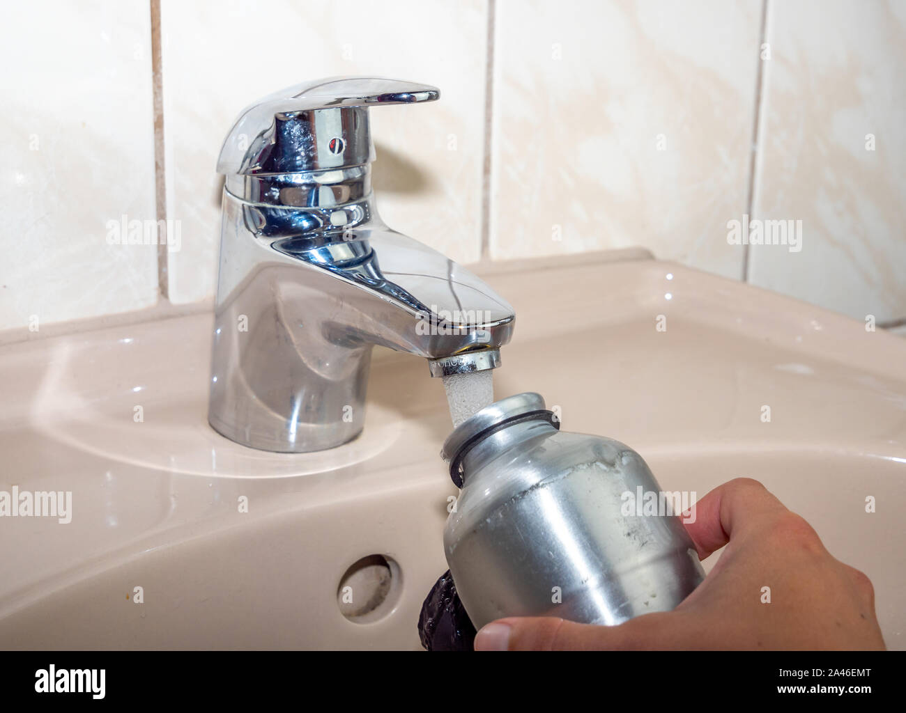 A drinking bottle is refilled Stock Photo - Alamy