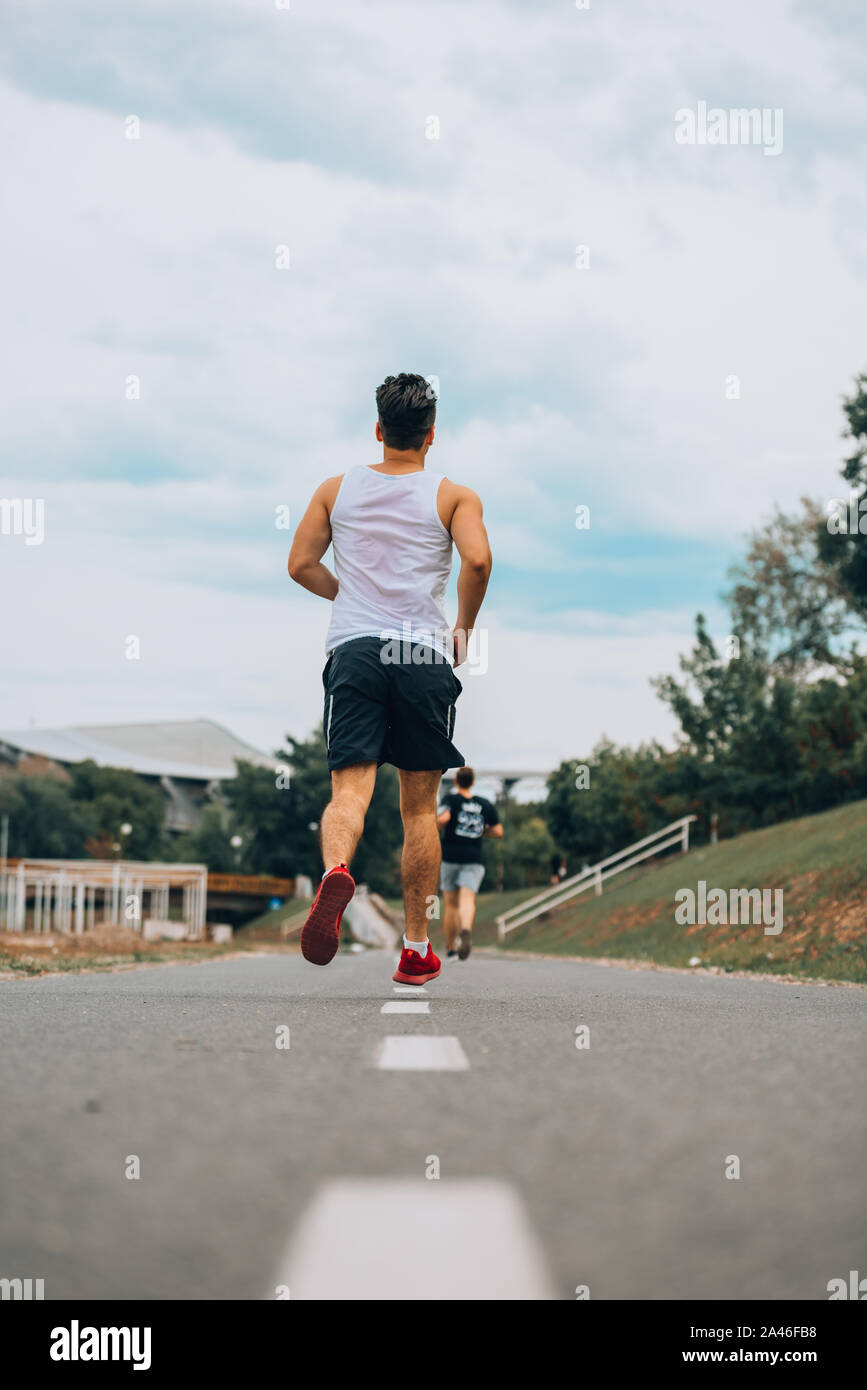 Running man runner training doing outdoor city run sprinting Stock ...