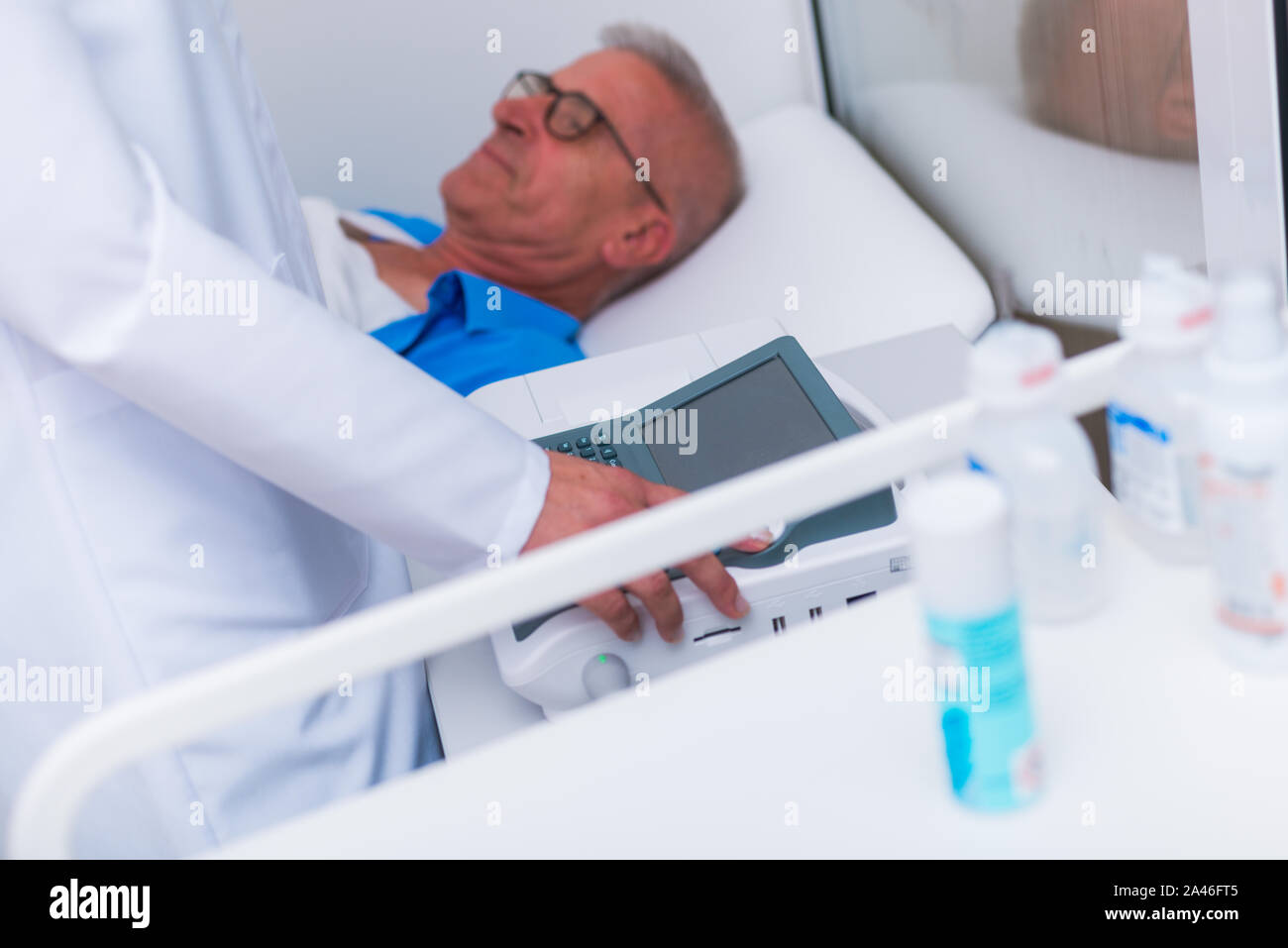 Close up of a Female (doctor) nurse performs an EKG test on an older ...