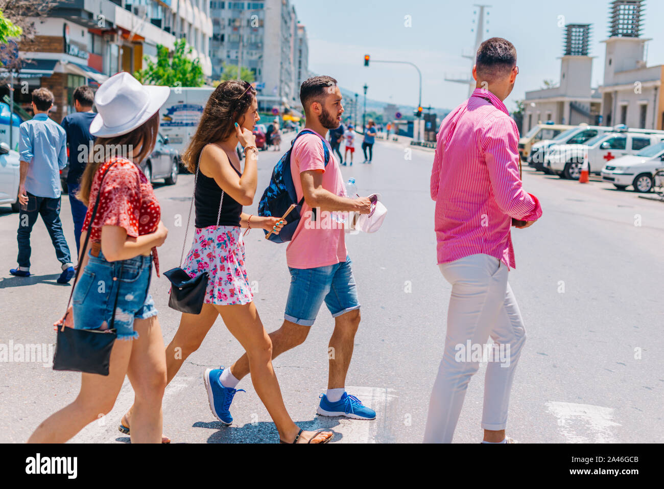 Tourists sightseeing and walking at a modern city boardwalk on a ...