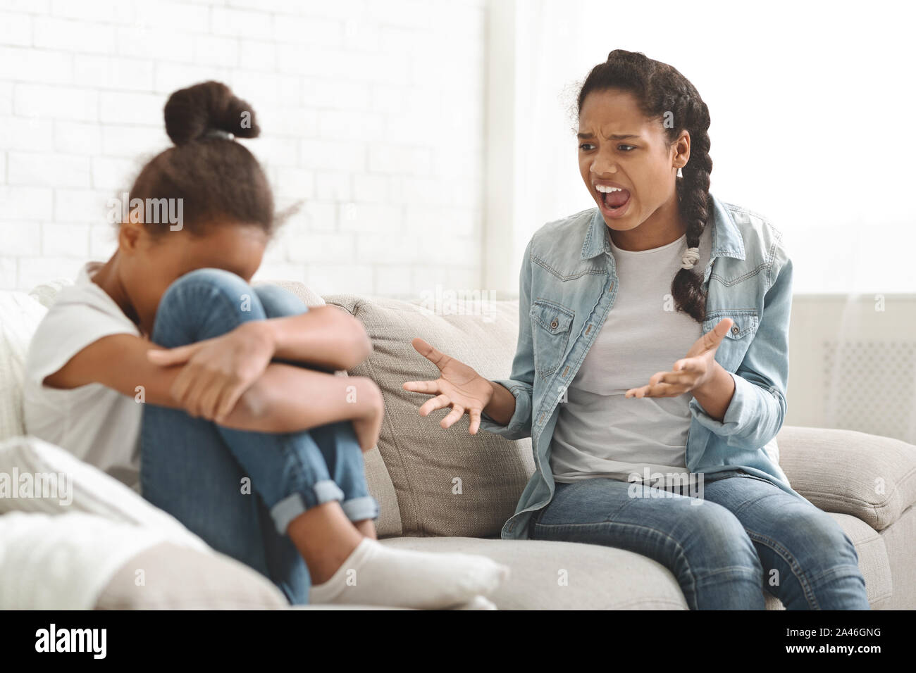 Girl shouting at younger sister, fighting at home Stock Photo - Alamy