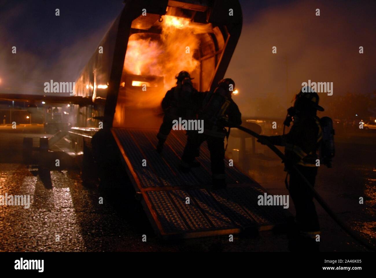 Federal firefighters combat a fire during aircraft training evolution ...