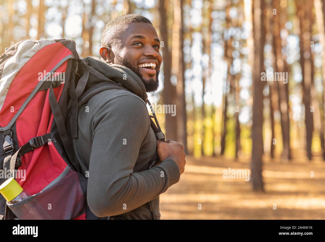 African man wearing backpack standing on forest trail Stock Photo - Alamy