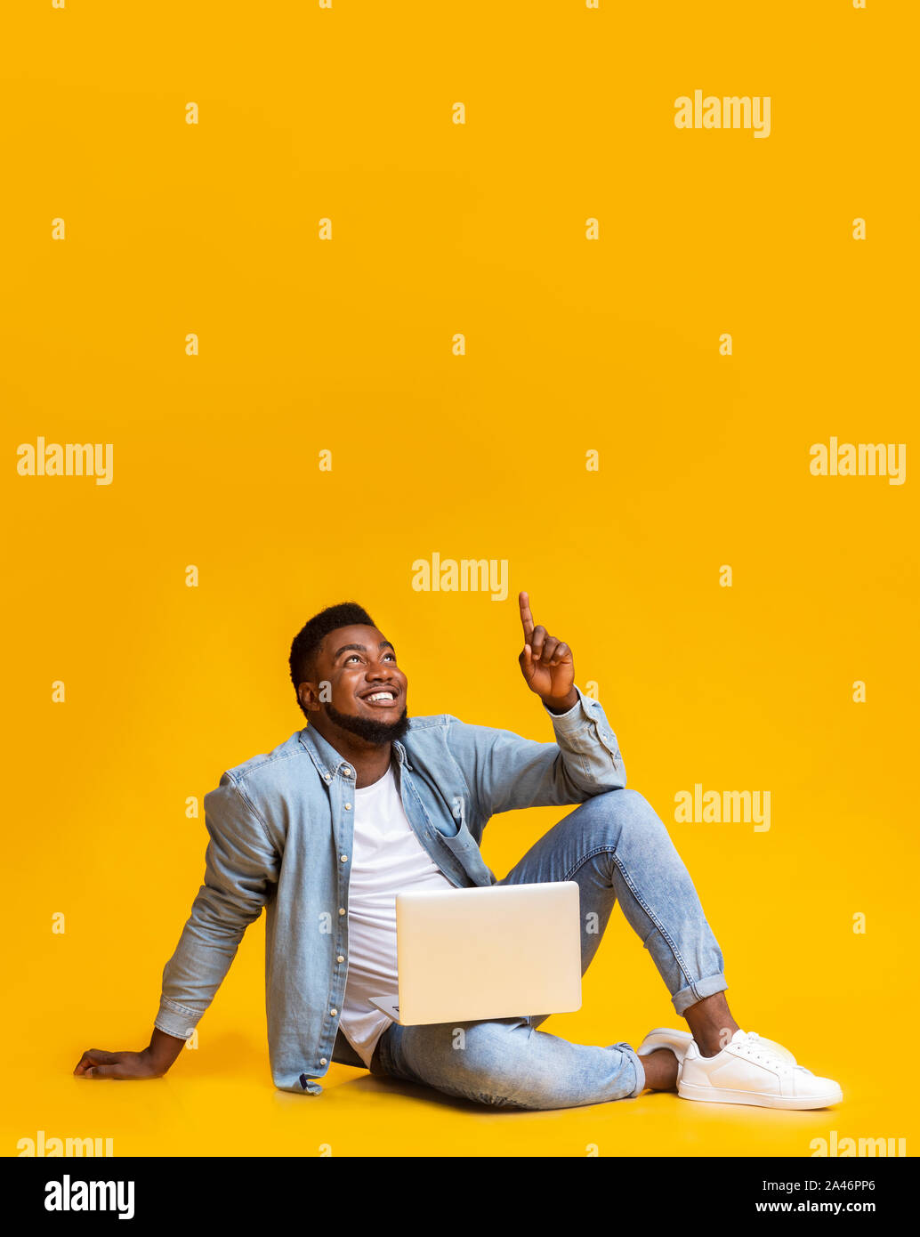 Excited african man laptop pointing hi-res stock photography and images ...