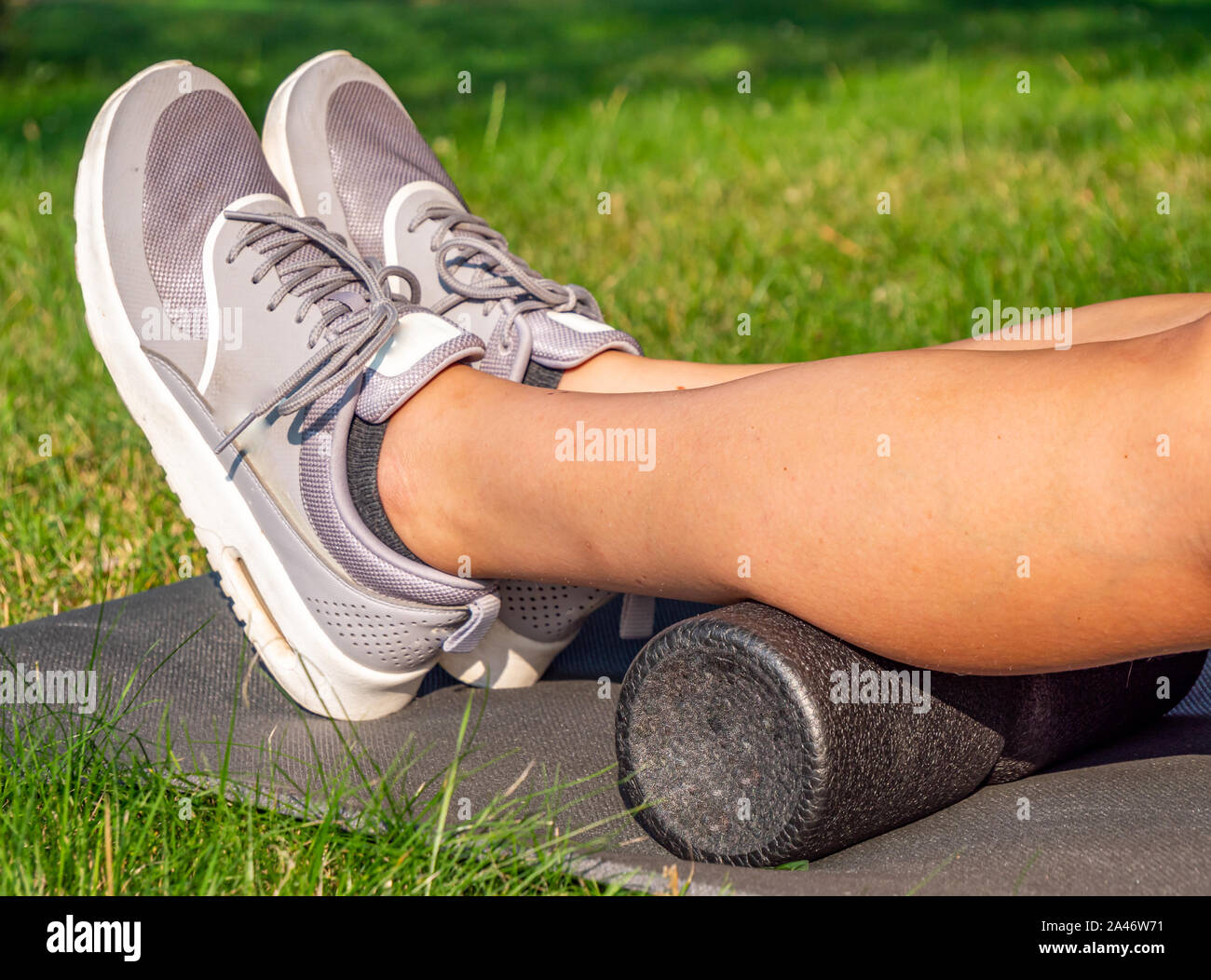 Exercise with a fascia role outdoors Stock Photo - Alamy