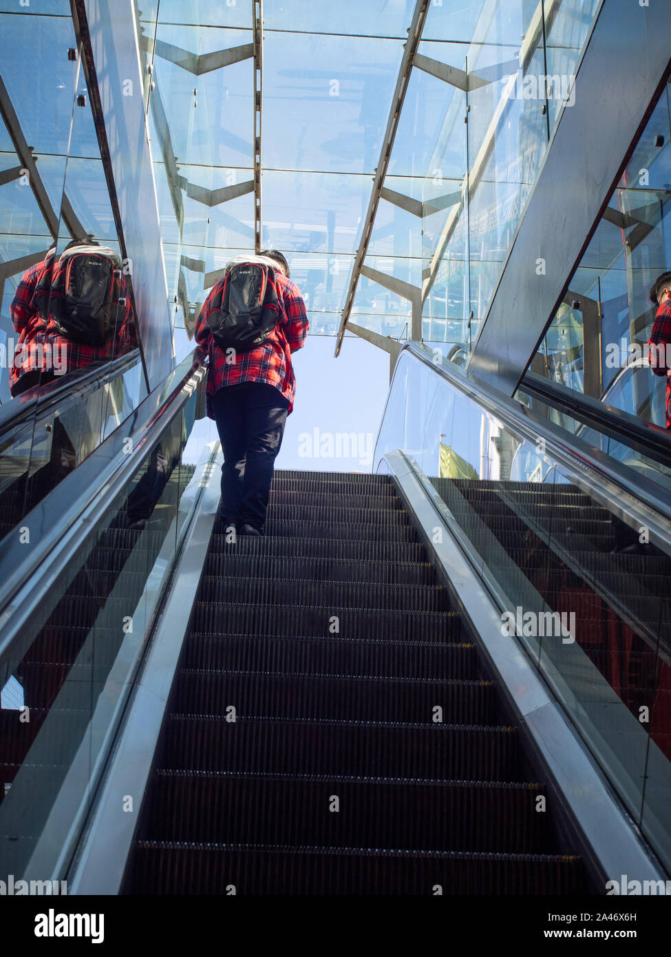 Person Going Up On An Escalator Stock Photo - Alamy