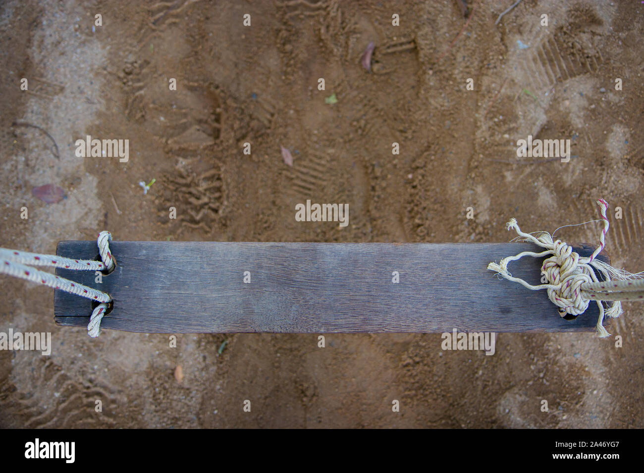 The old rope wooden swing. A regular home made swing made of rope and a ...