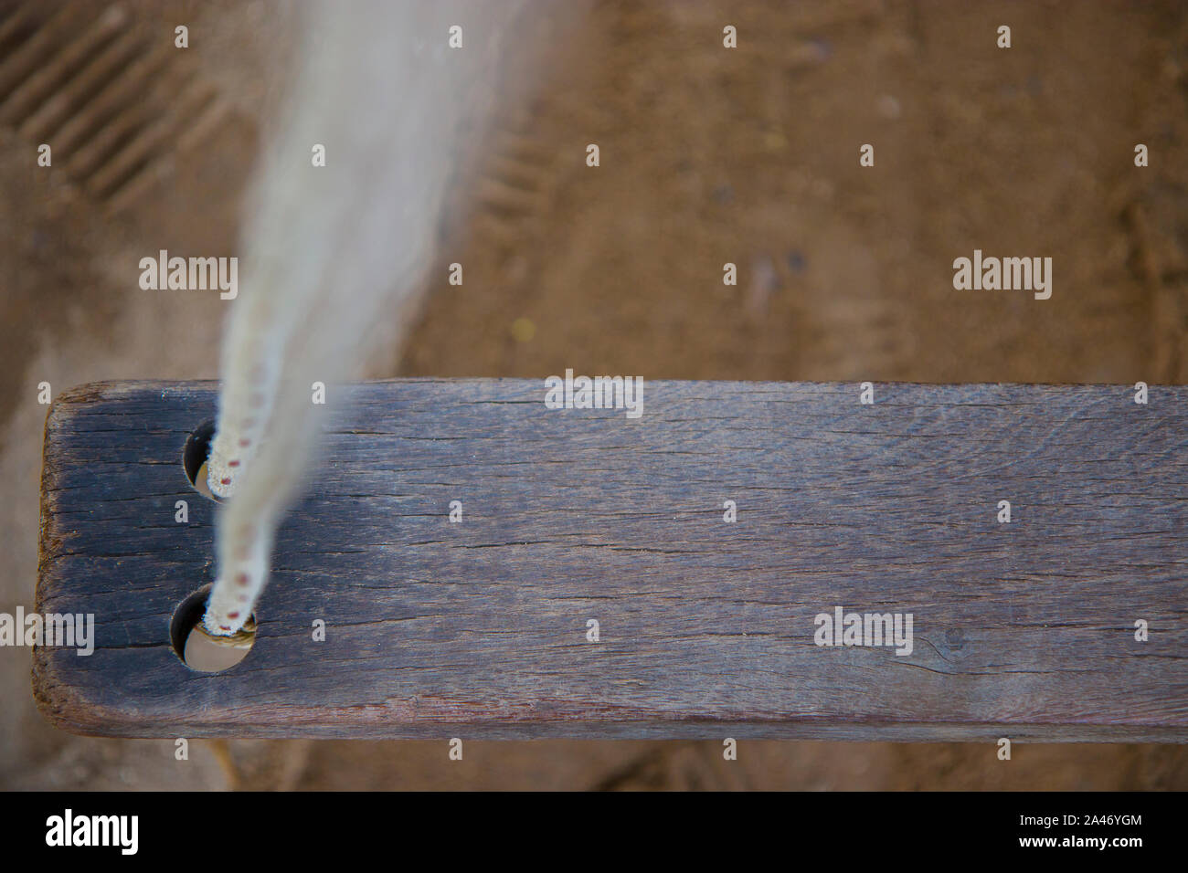 The old rope wooden swing. A regular home made swing made of rope and a ...