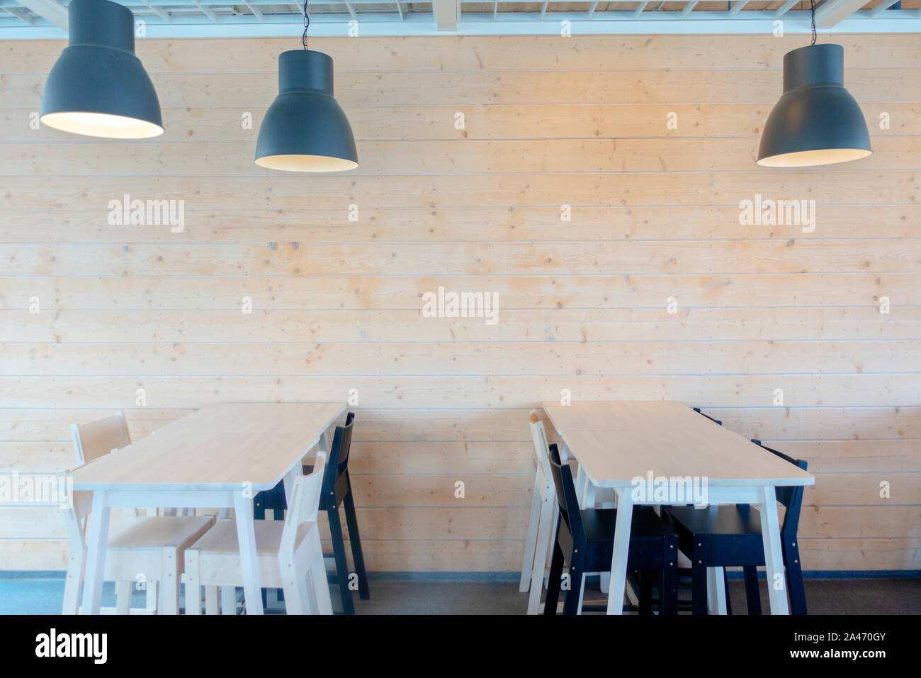 Modern cafe, bar or club interior with high wooden tables and chairs ...