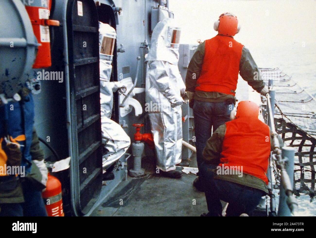 Fire party on standby during flight operations aboard USS Pharris (DE ...