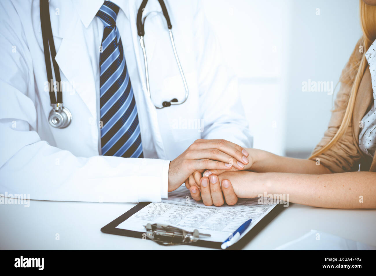 Hand of doctor reassuring her female patient. Concepts of medical ...
