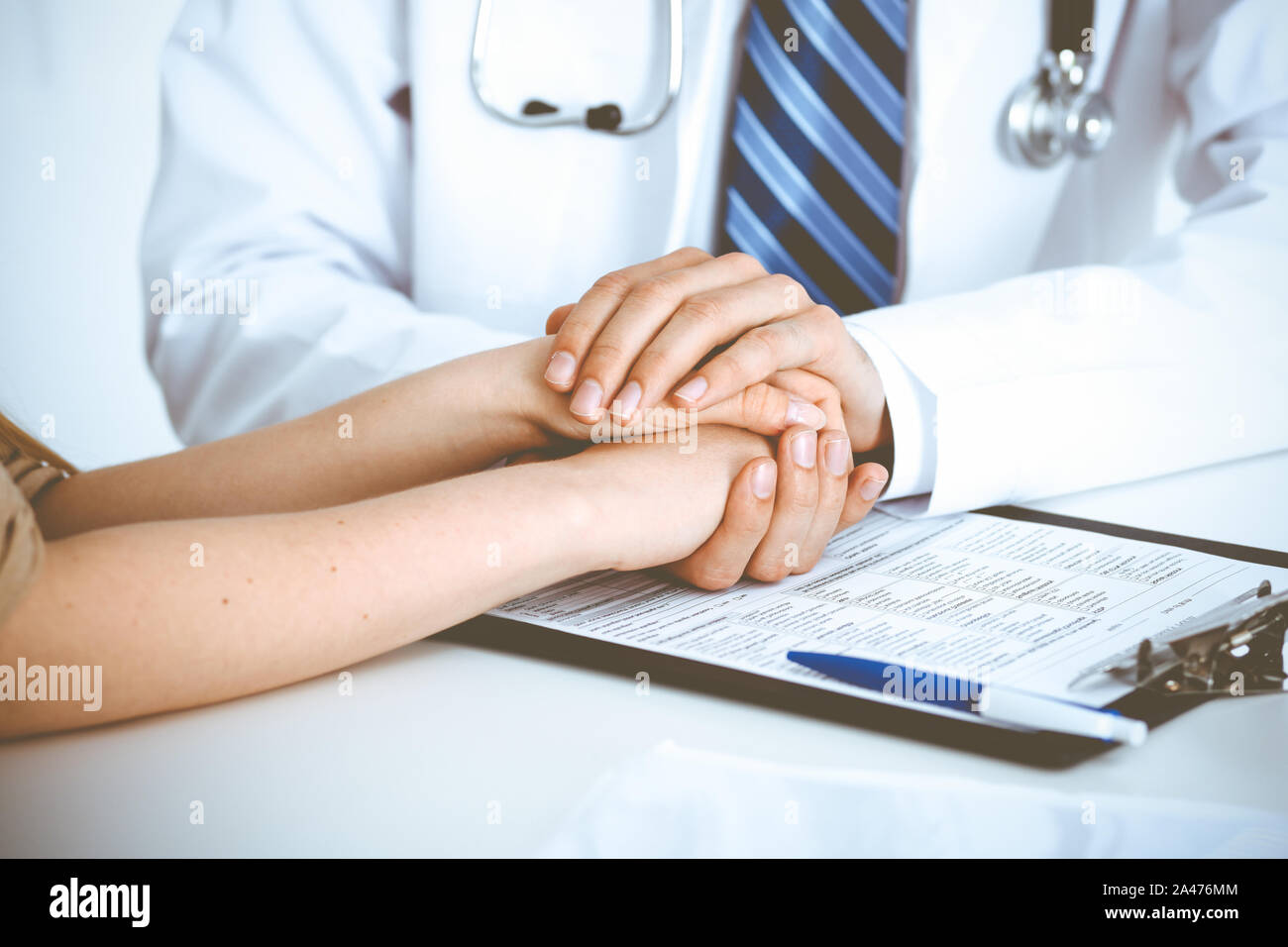 Hand of doctor reassuring her female patient. Concepts of medical ...