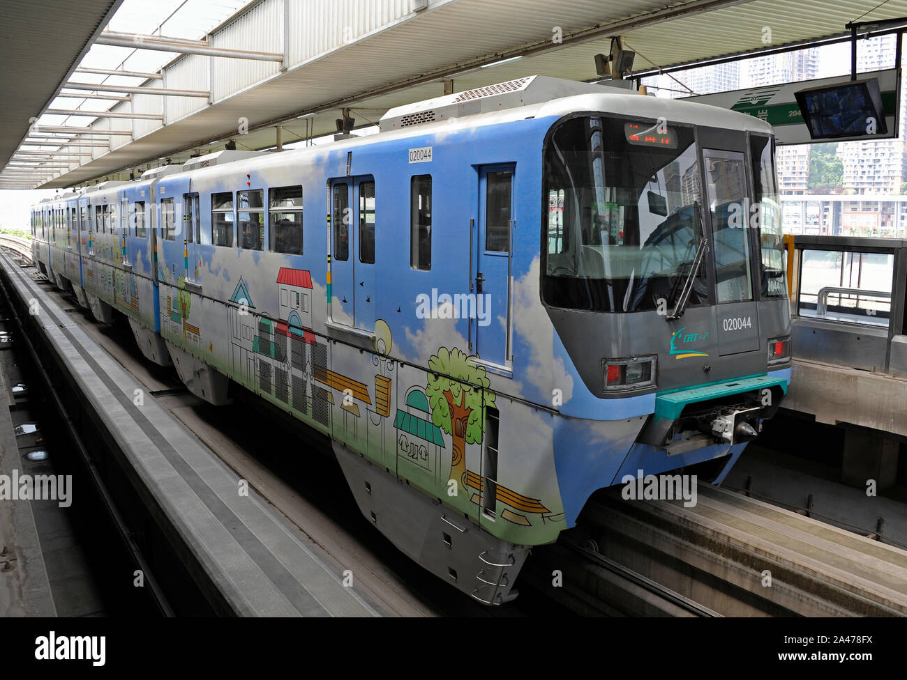 Brightly-painted monorail train waits at the platform at Huanghuayuan ...