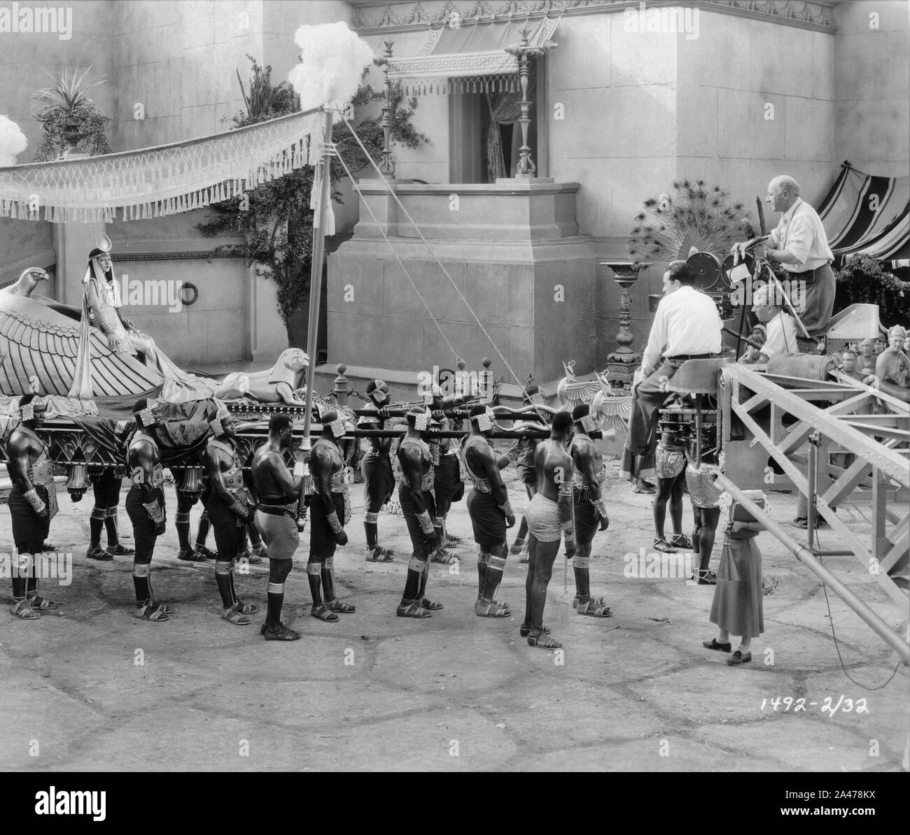 CLAUDETTE COLBERT as CLEOPATRA 1934 director CECIL B. DeMILLE on set candid filming entry into ...