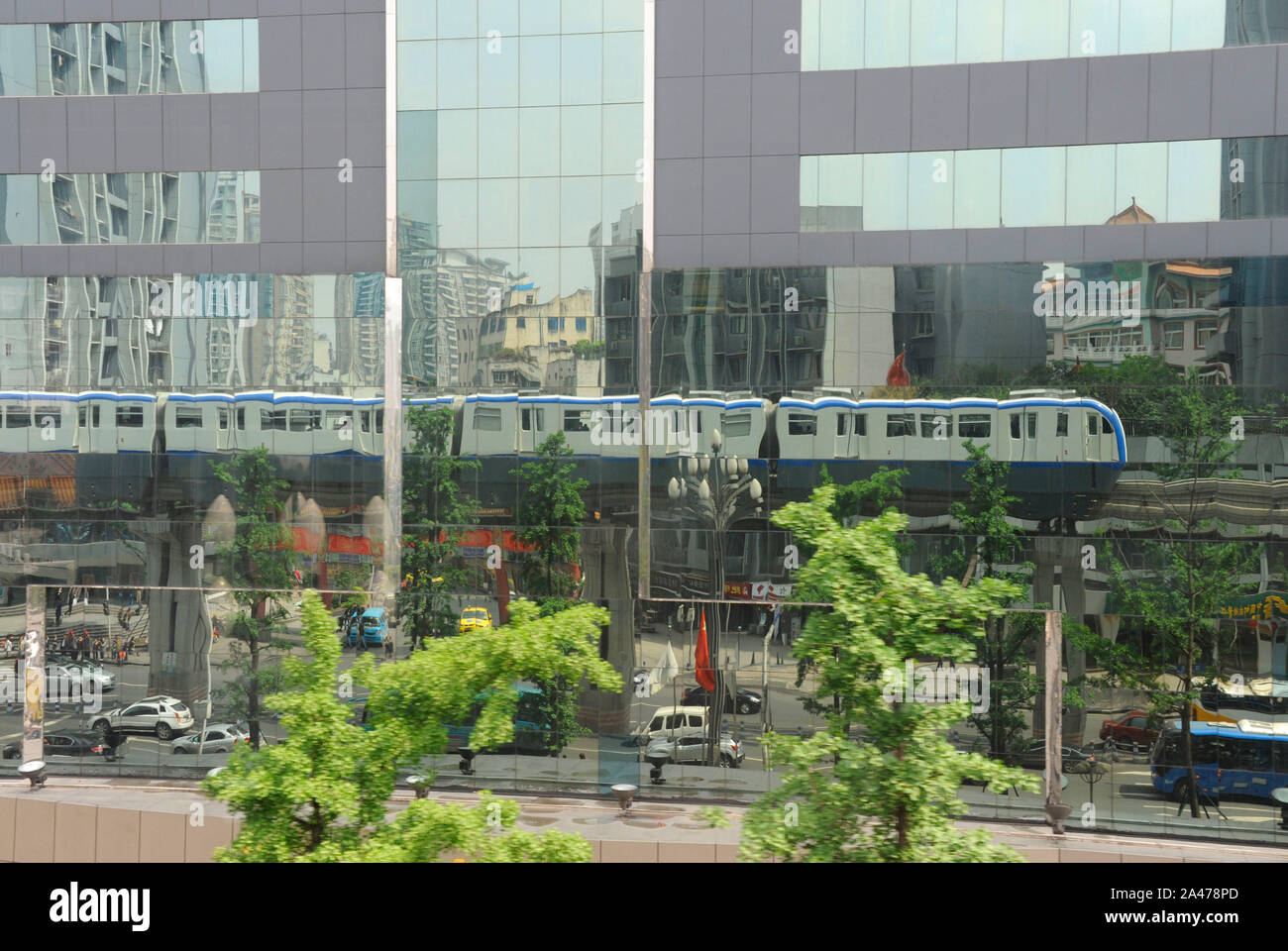 Reflection of a line 3 monorail train in the window of an office ...