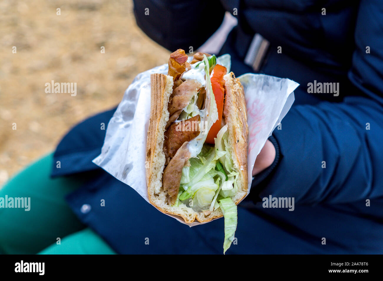 Woman has a kebab in her hand Stock Photo - Alamy
