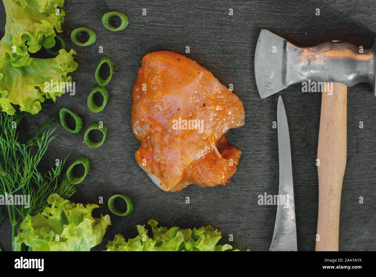 Slice of pickled turkey fillet on a kitchen cutting board background ...
