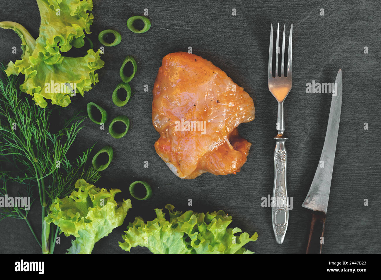 Slice of pickled turkey fillet on a kitchen cutting board background ...