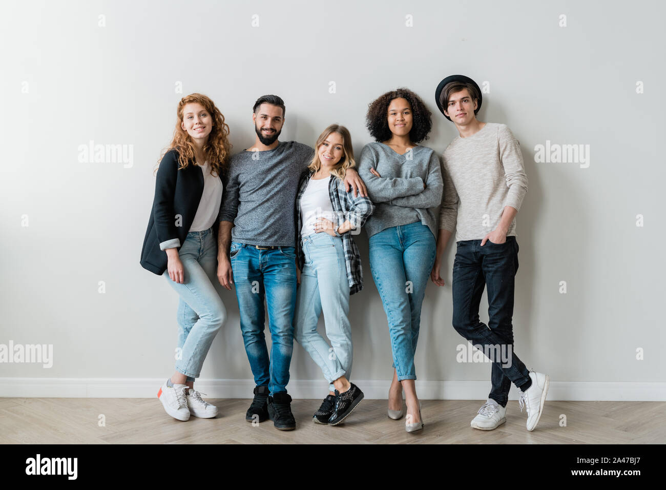 Group of people standing against wall hi-res stock photography and ...
