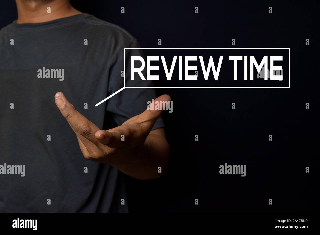 Young man pointed Review Time text isolated on black background Stock ...