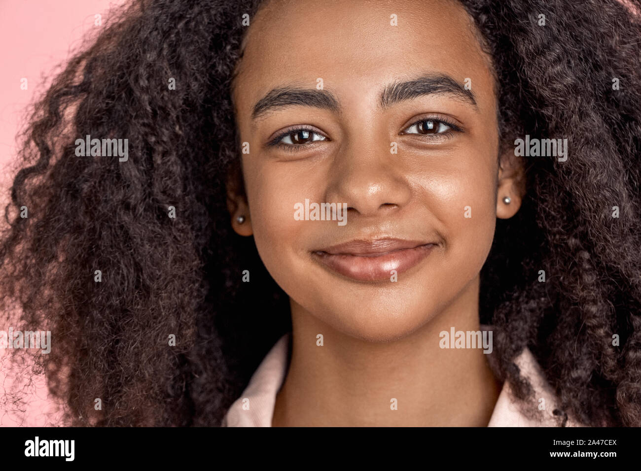 Freestyle. African girl standing isolated on pink smiling happy face ...