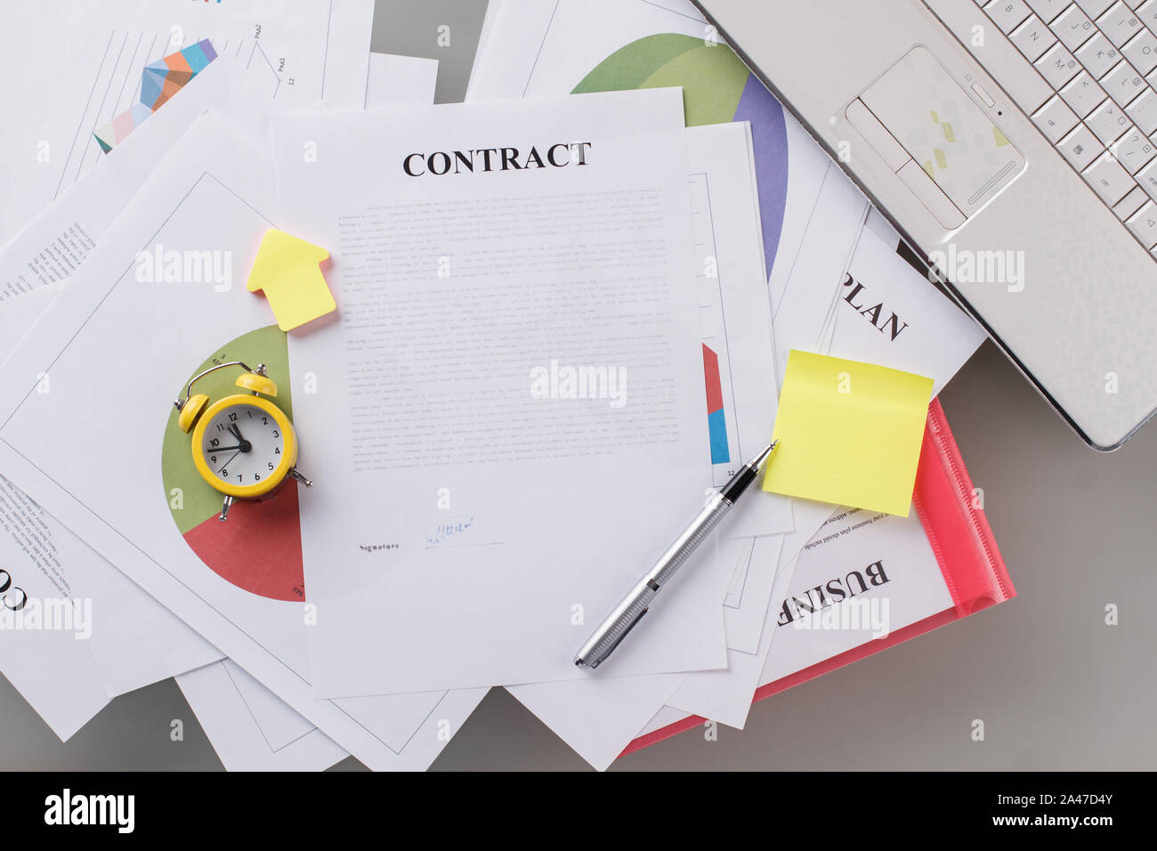 Signed contract on tabletop Stock Photo - Alamy