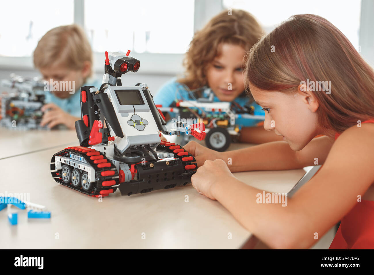 Robotics. Children having class sitting making robots girl close-up ...