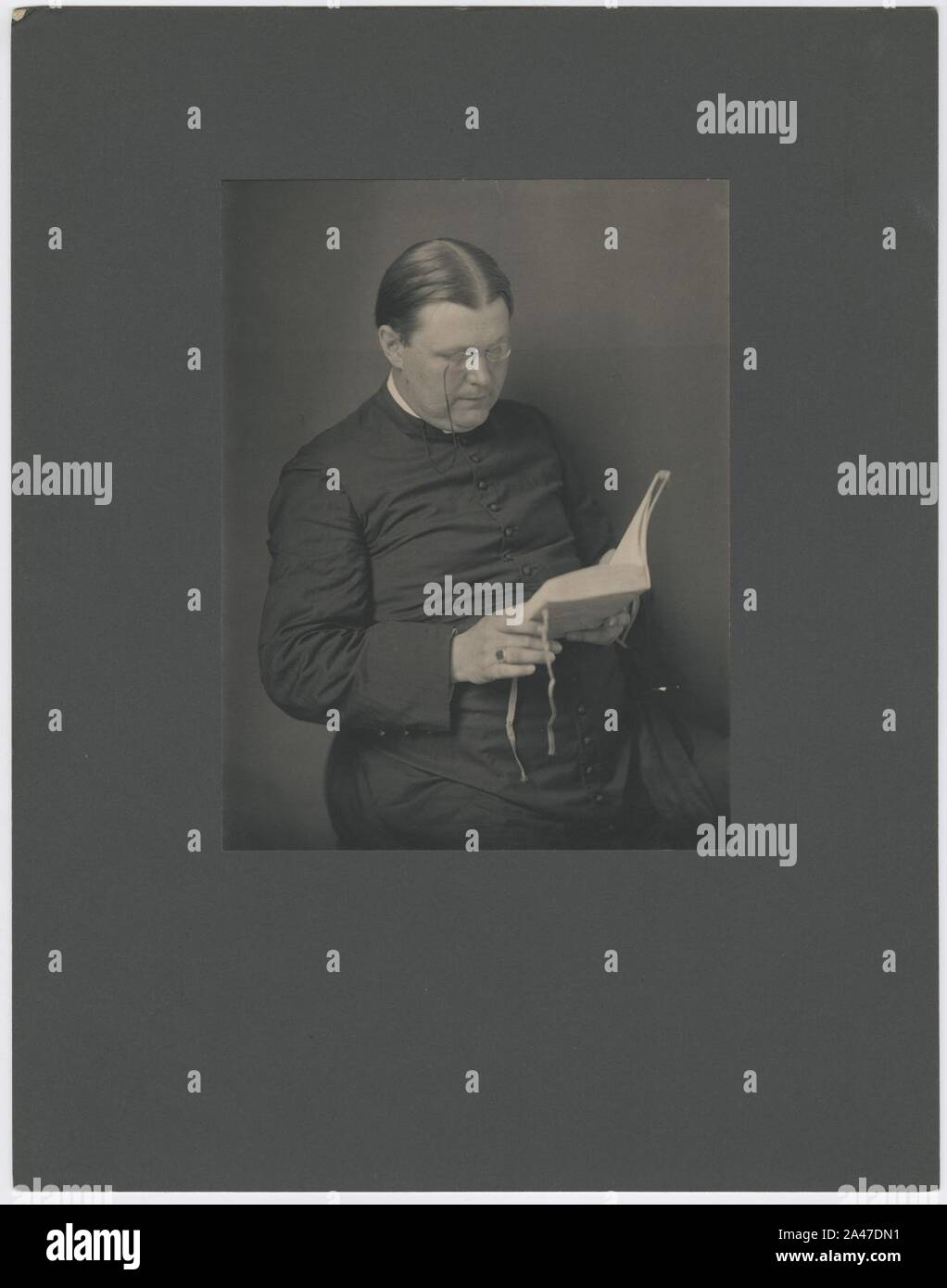 Father William Harman van Allen reading a book Stock Photo - Alamy