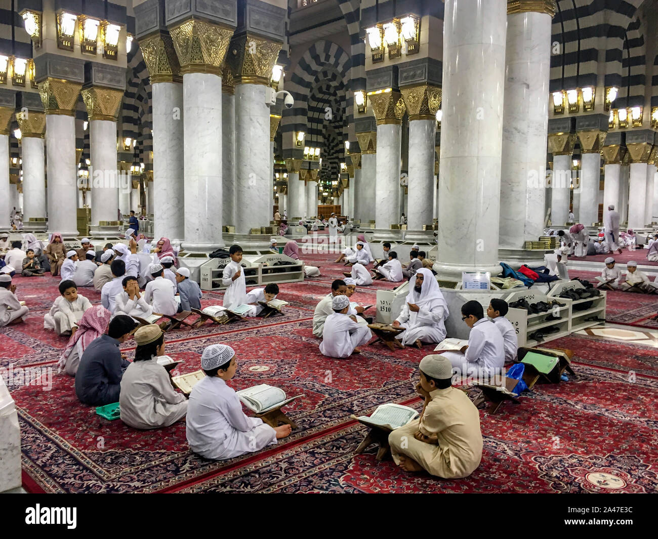 MEDINA, SAUDI ARABIA - JUNE 25: Muslim children learning Quran or Koran ...