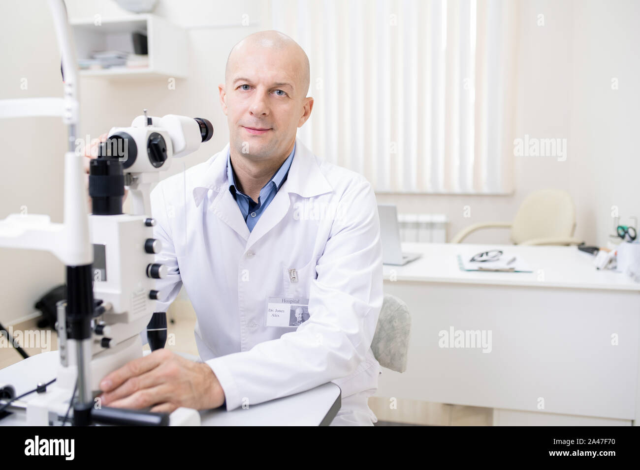 Successful professional optometrist working with new eyesight check-up ...