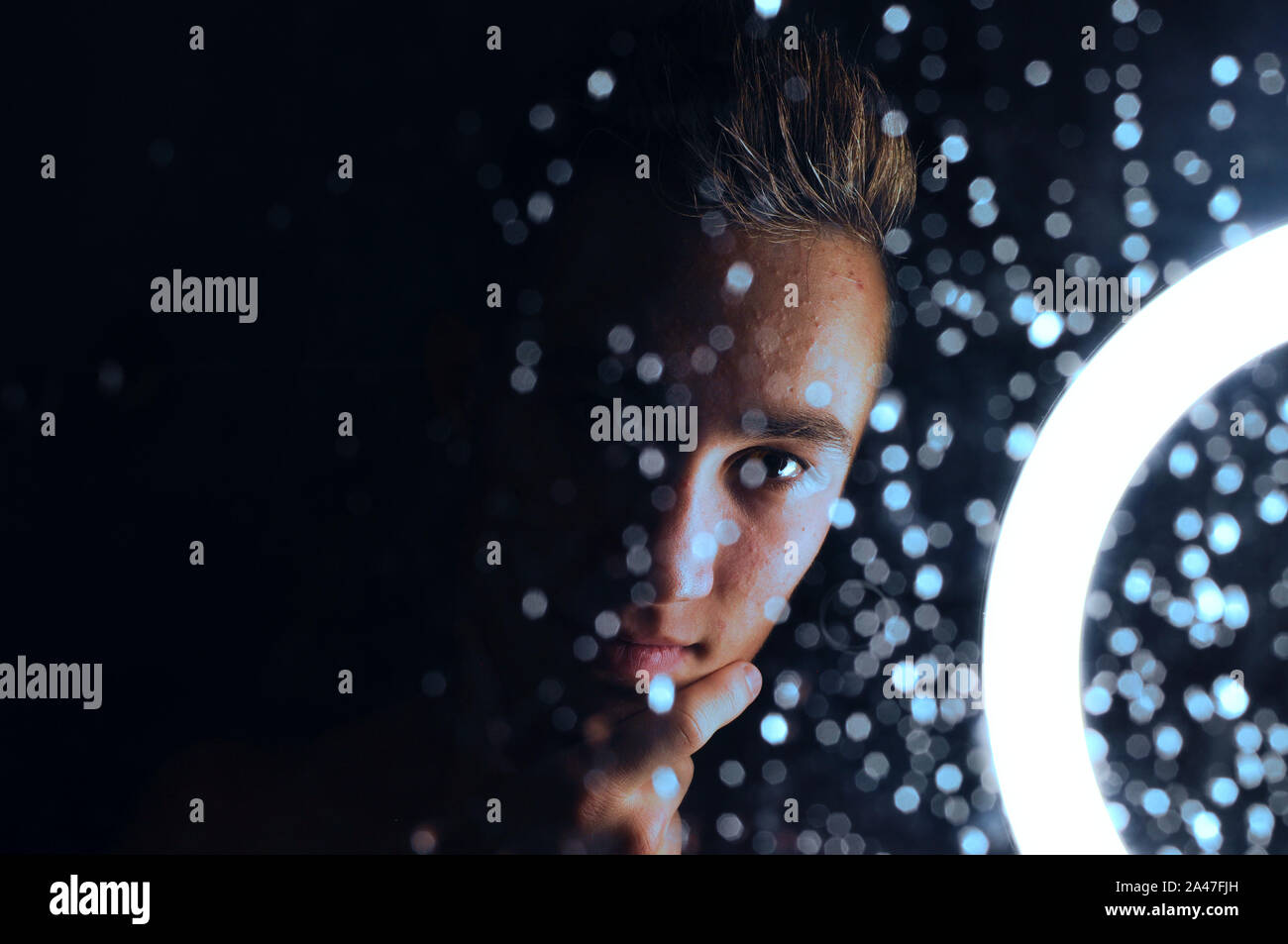 A picture of a man behind drops of water Stock Photo - Alamy