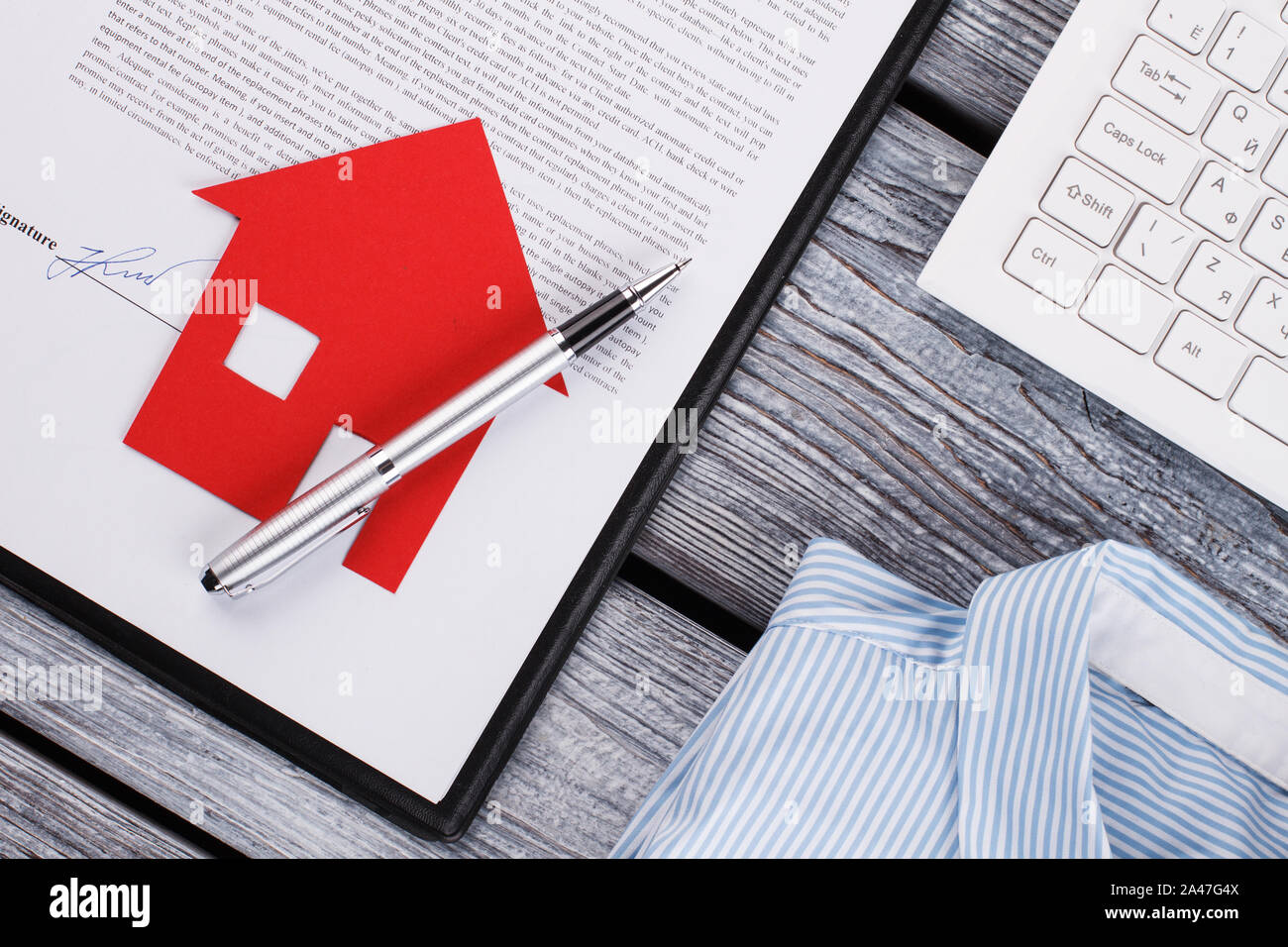 Signed contract, paper house and pen Stock Photo - Alamy