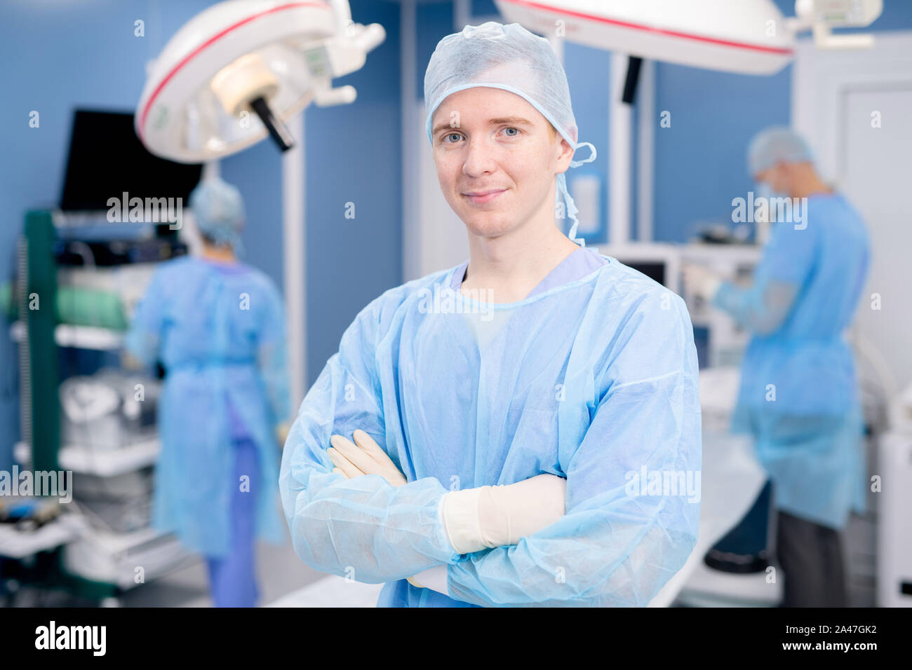Successful professional in uniform of surgeon crossing his arms on ...