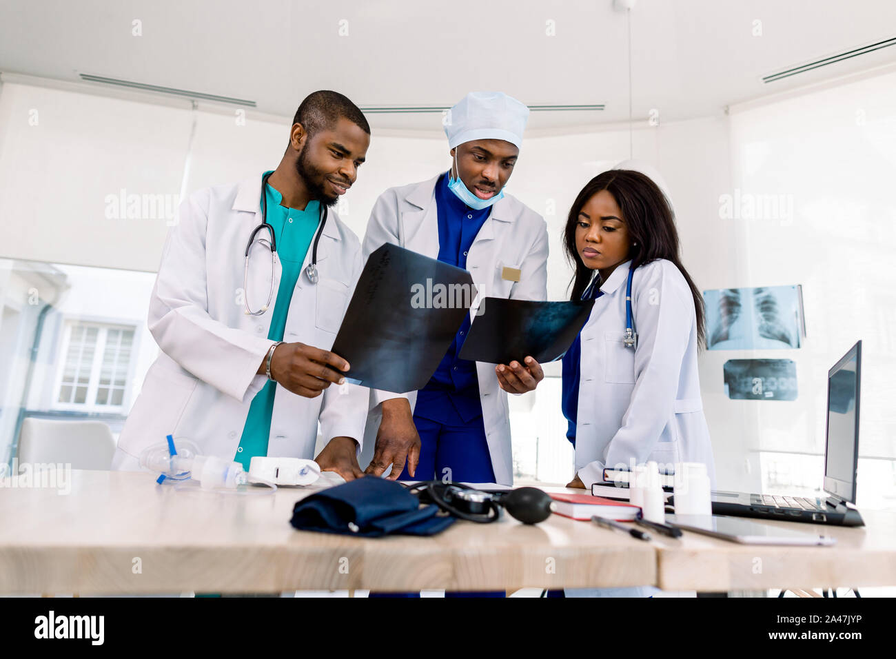 radiology, people and medicine concept - group of three African doctors ...