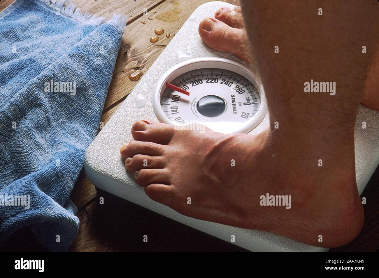 Feet on scale Stock Photo - Alamy
