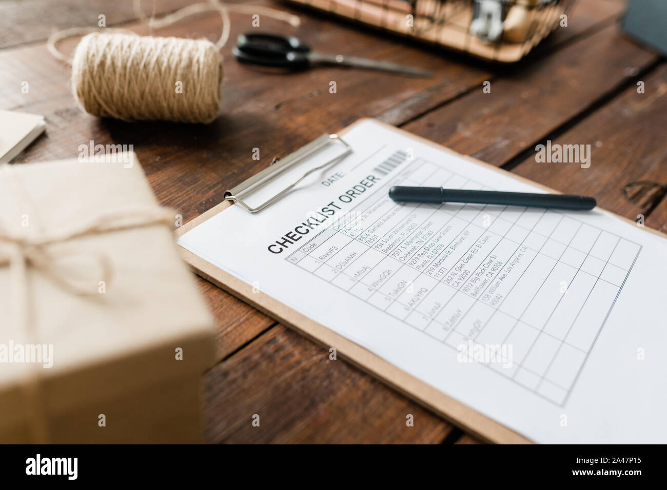Clipboard with document and pen, spool of threads, packed box and other ...