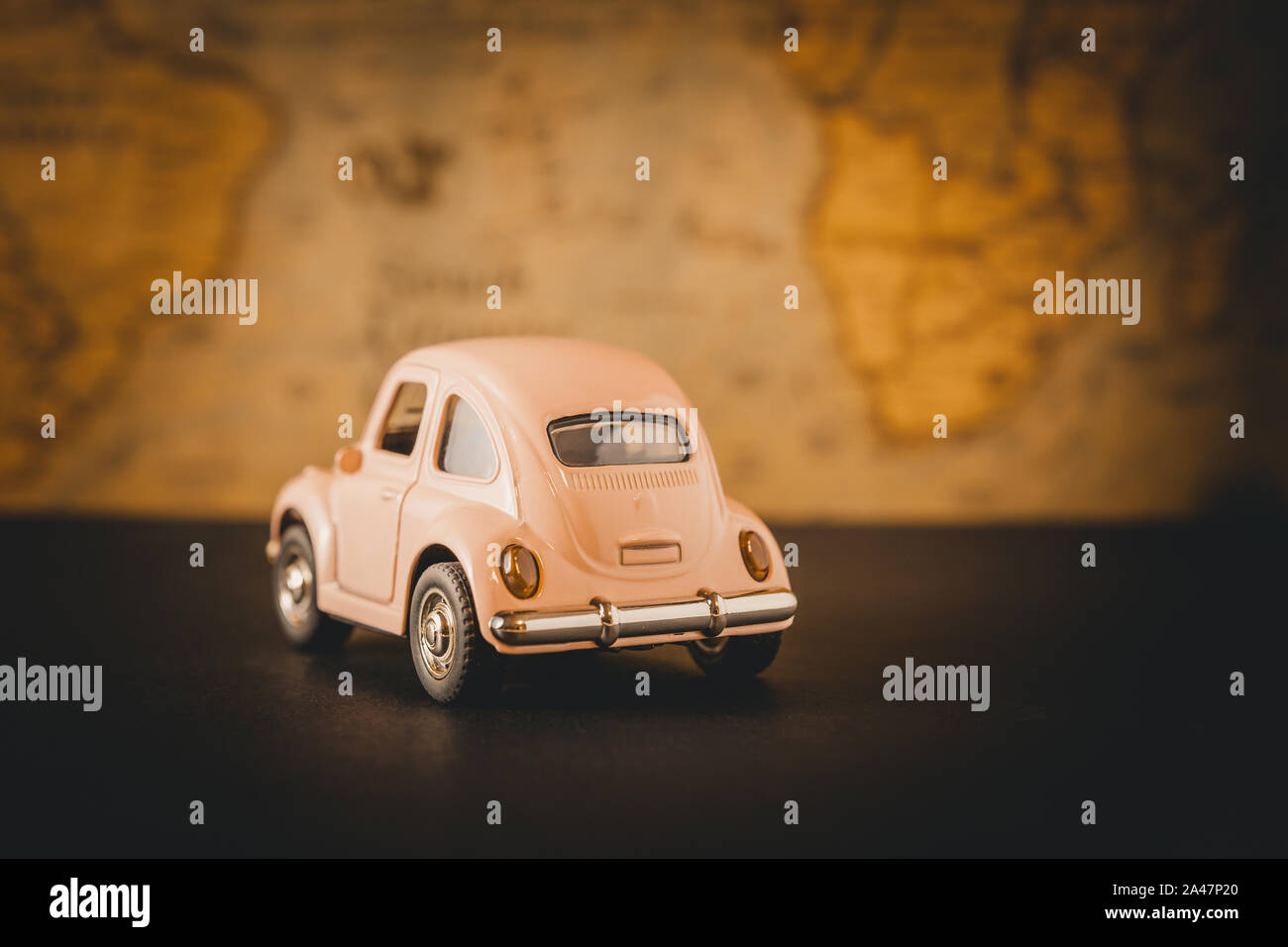 Little pink car on vintage card background, travel or vacation planning ...