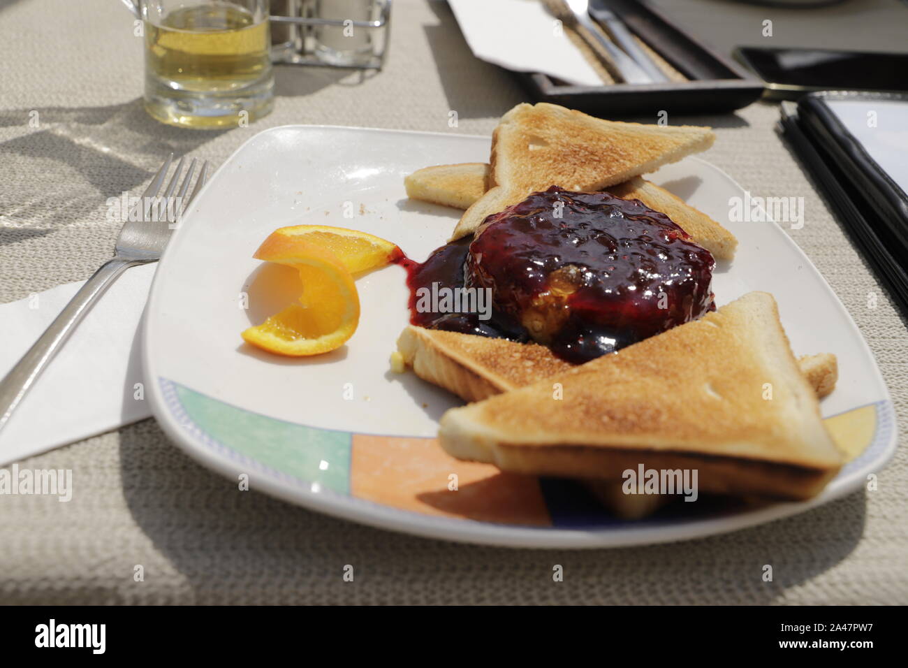 Toast with melted goat cheese and cranberry sauce Stock Photo - Alamy