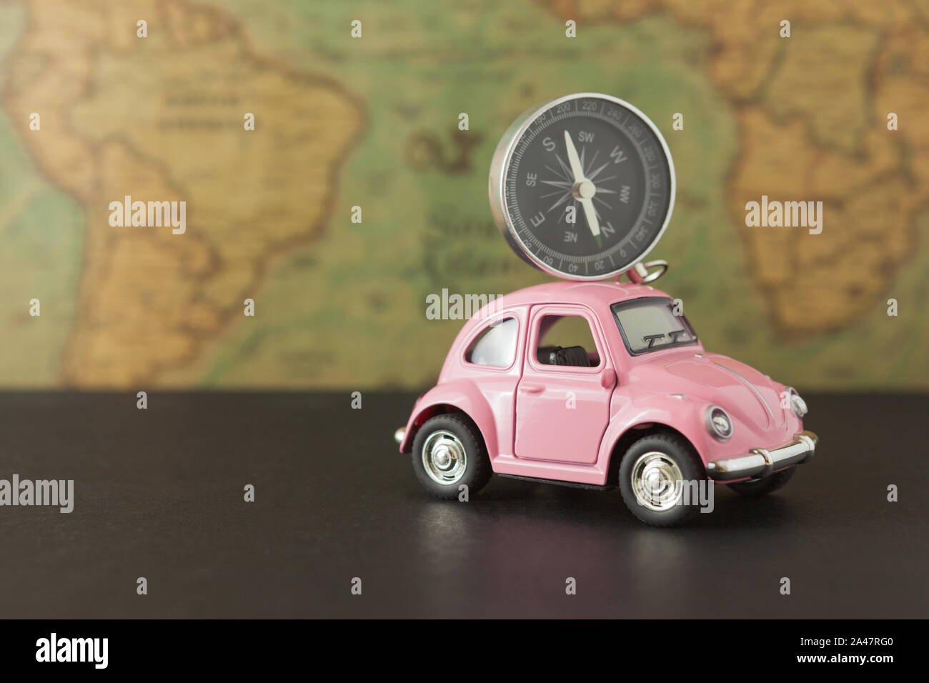 Pink car and compass on vintage map background, concept of travel and ...