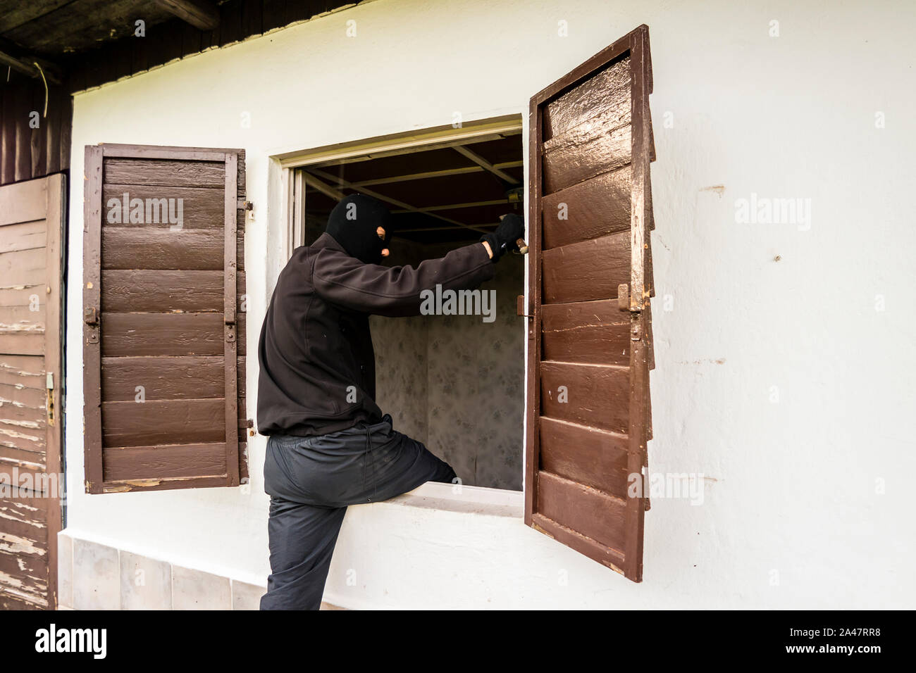 Burglar opening window hi-res stock photography and images - Alamy